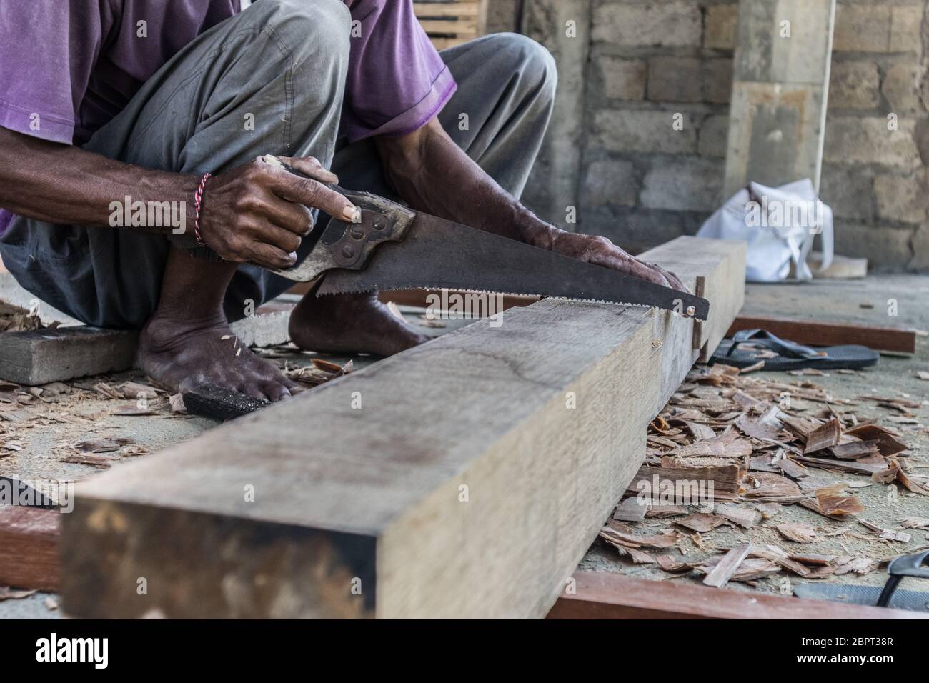 Close up of warn hands of carpenter working with manual tools in ...