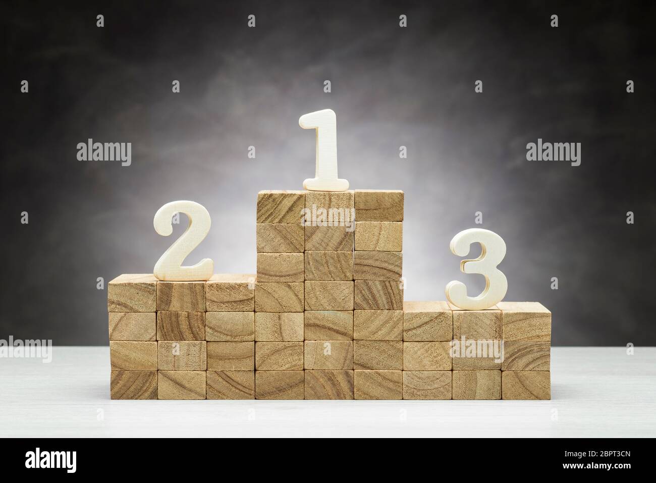 Concept of competition. Wooden podium on grey background with numbers ...