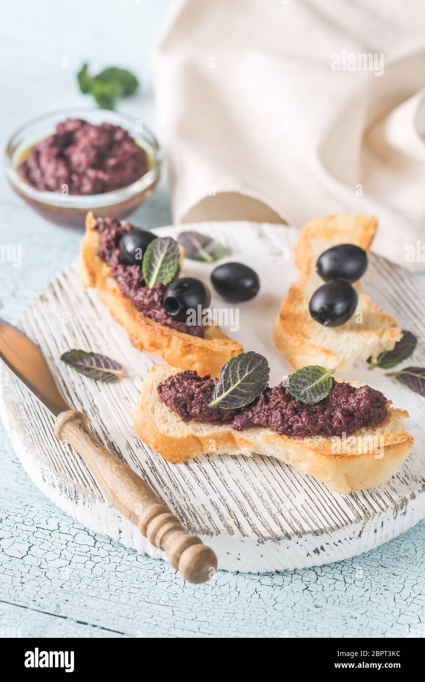 Toasts with black olive pate Stock Photo - Alamy