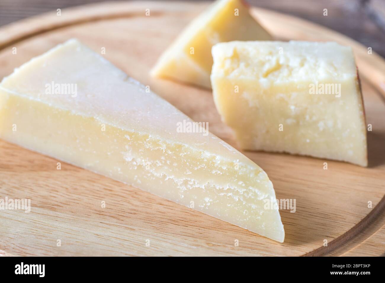 Grana Padano cheese on the wooden board Stock Photo - Alamy