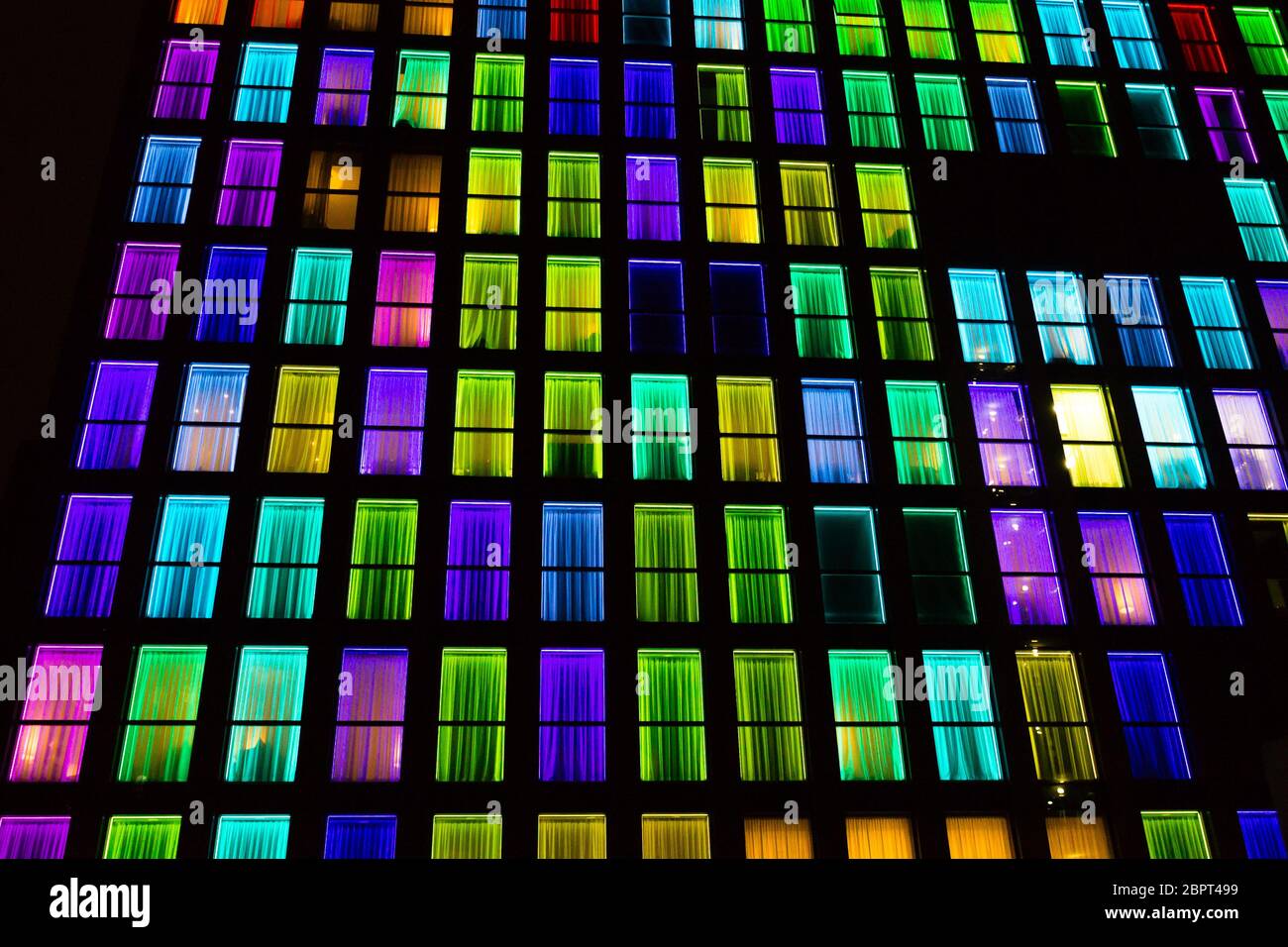 Colored windows texture. Windows illuminated by neon lights background ...