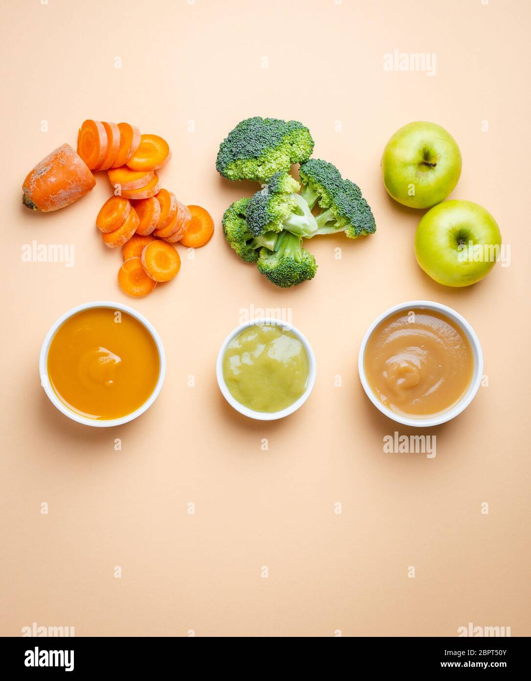 White bowls with healthy natural baby food on pastel background. Purees ...