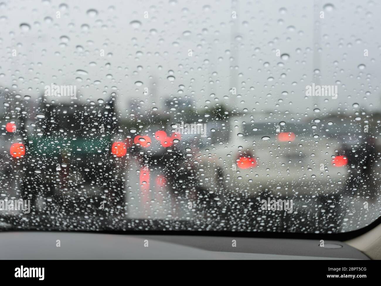 Blurry driving car seen through wet windscreen in rainy day Stock Photo ...