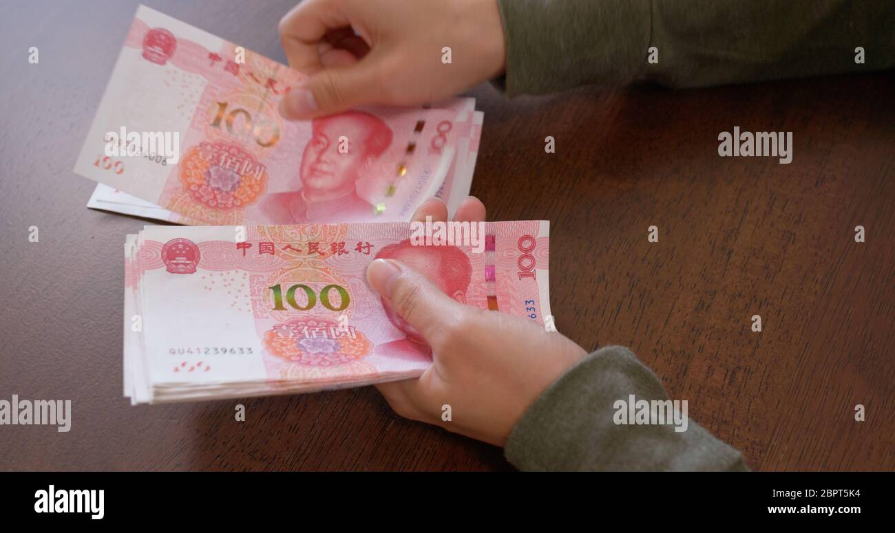 Woman counting RMB banknote Stock Photo - Alamy