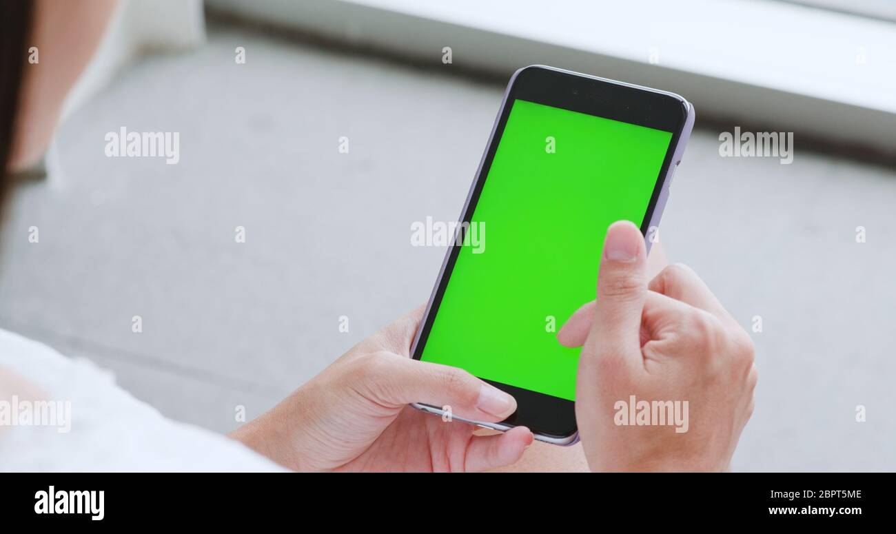 Woman use of smart phone with green screen, chroma key Stock Photo - Alamy