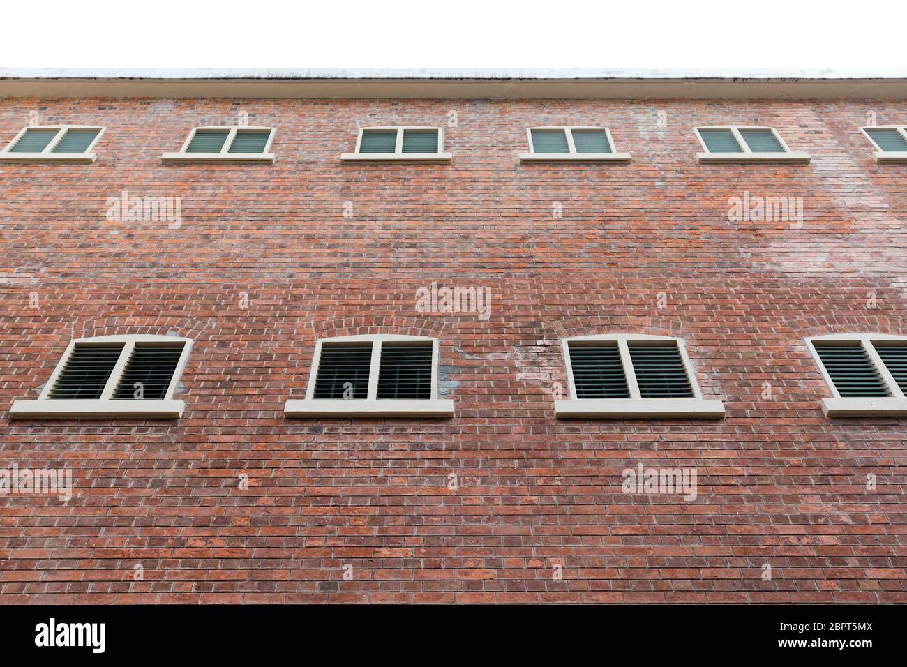 Red brick wall with window Stock Photo - Alamy