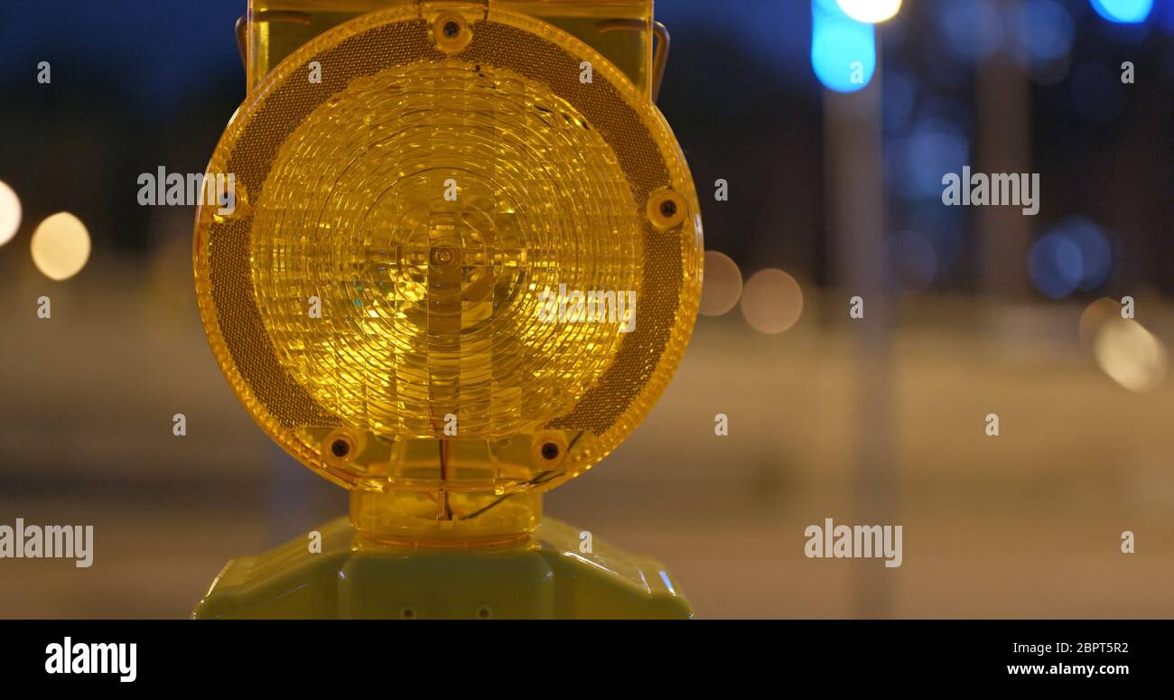 Yellow caution light in the street at night Stock Photo - Alamy