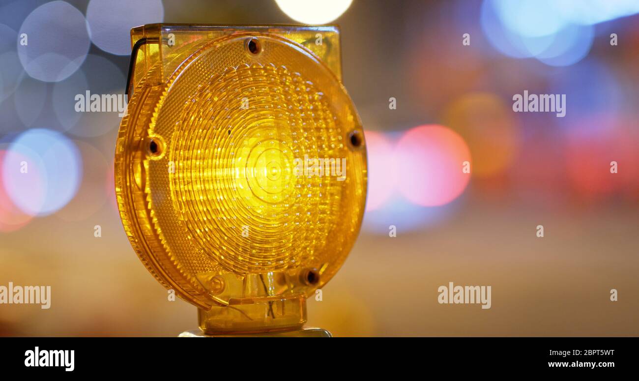 Yellow caution light in the street at night Stock Photo - Alamy