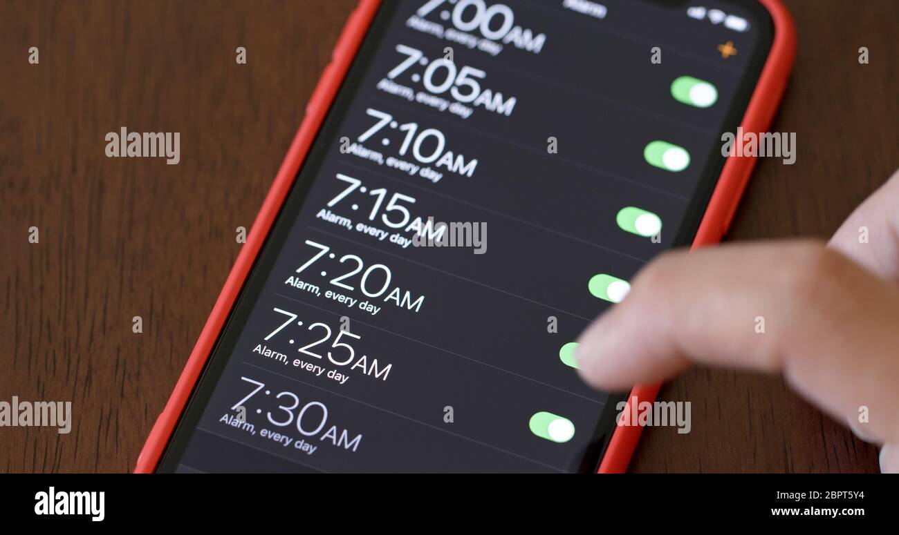 Woman, setting alarm clock hi-res stock photography and images - Alamy