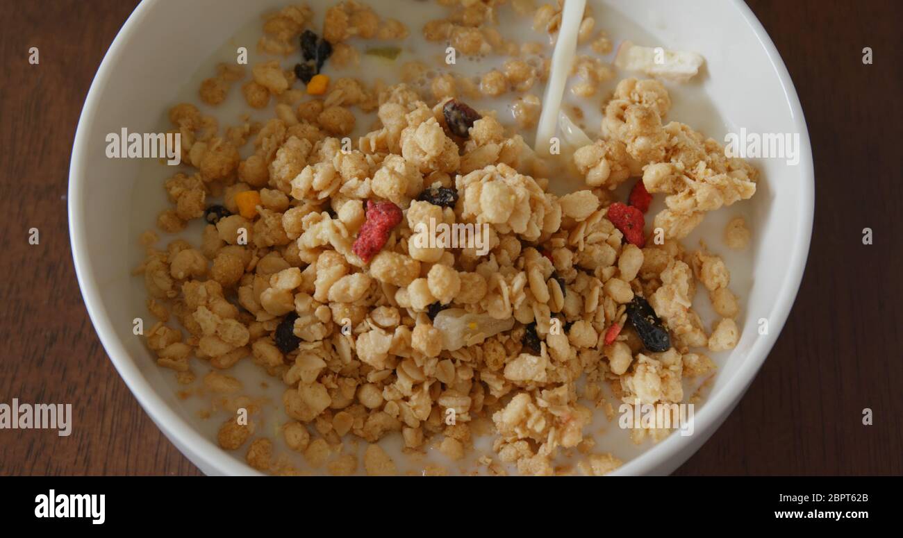 Adding milk into cereal Stock Photo - Alamy