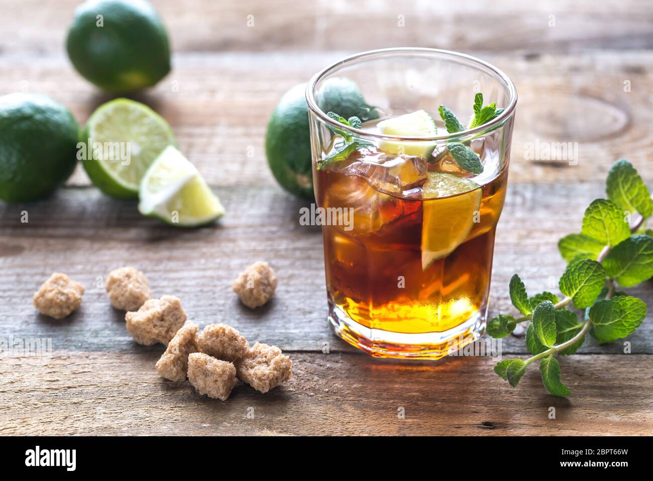 Glass of rum on the wooden background Stock Photo - Alamy