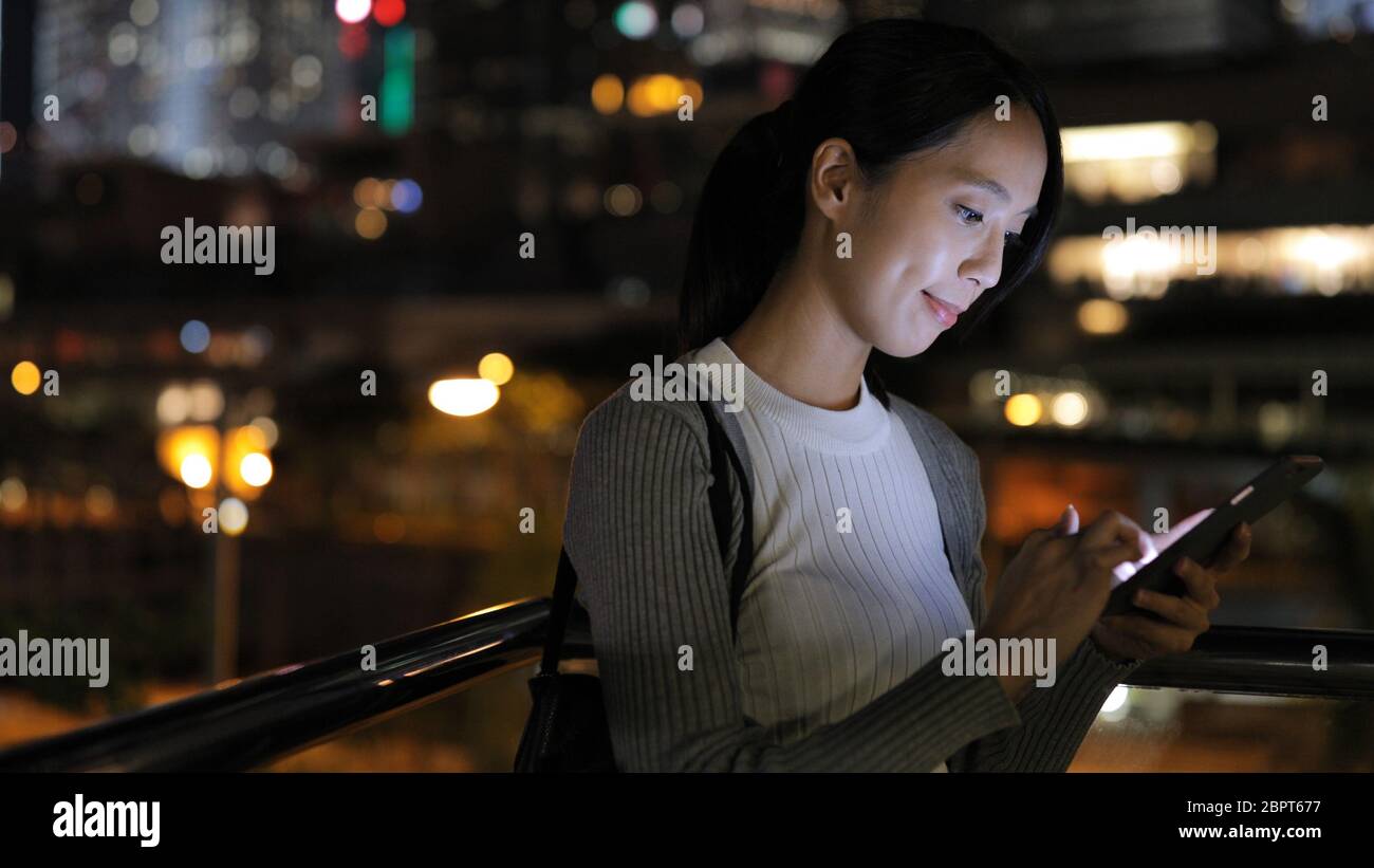 Woman watching on cellphone at night Stock Photo - Alamy