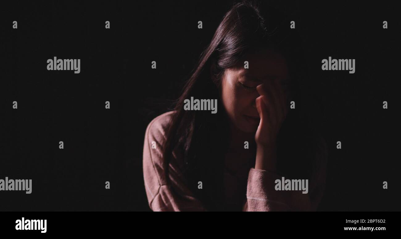 Woman crying in the dark Stock Photo - Alamy