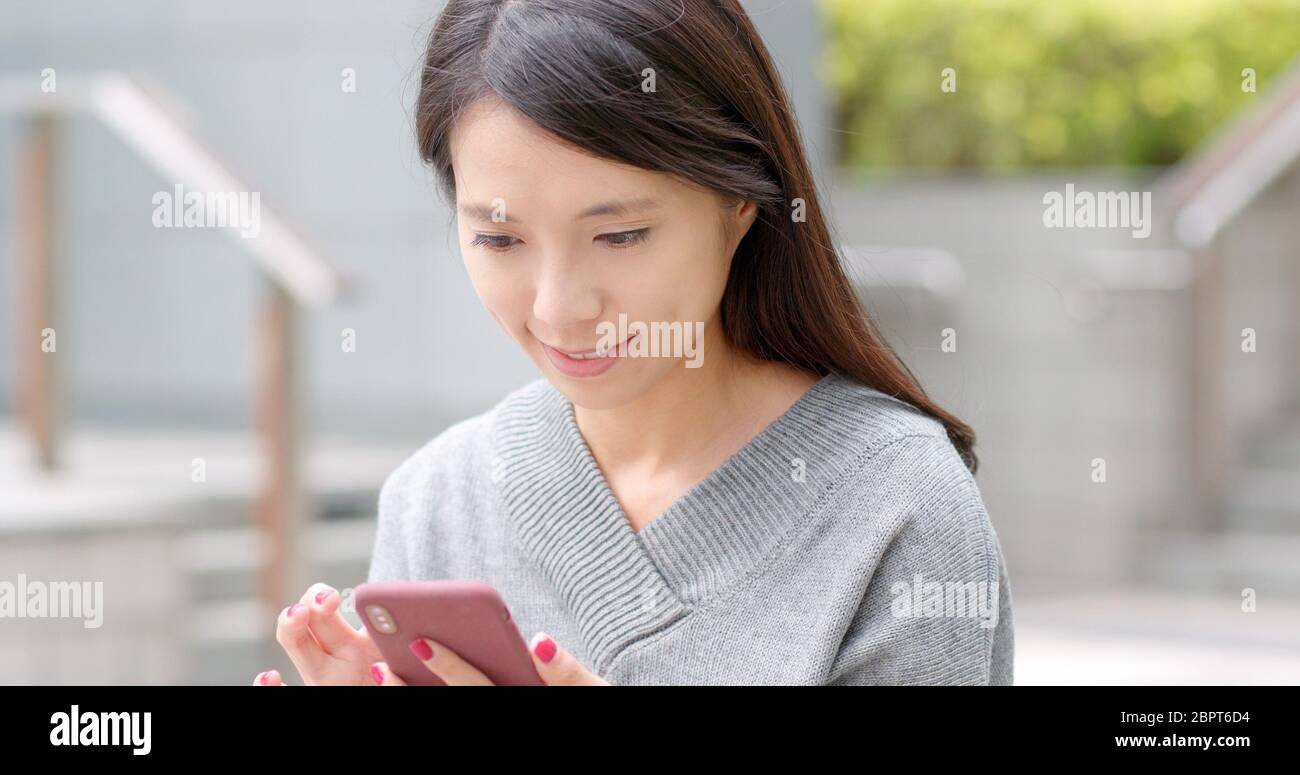 Woman use of mobile phone at outdoor Stock Photo - Alamy