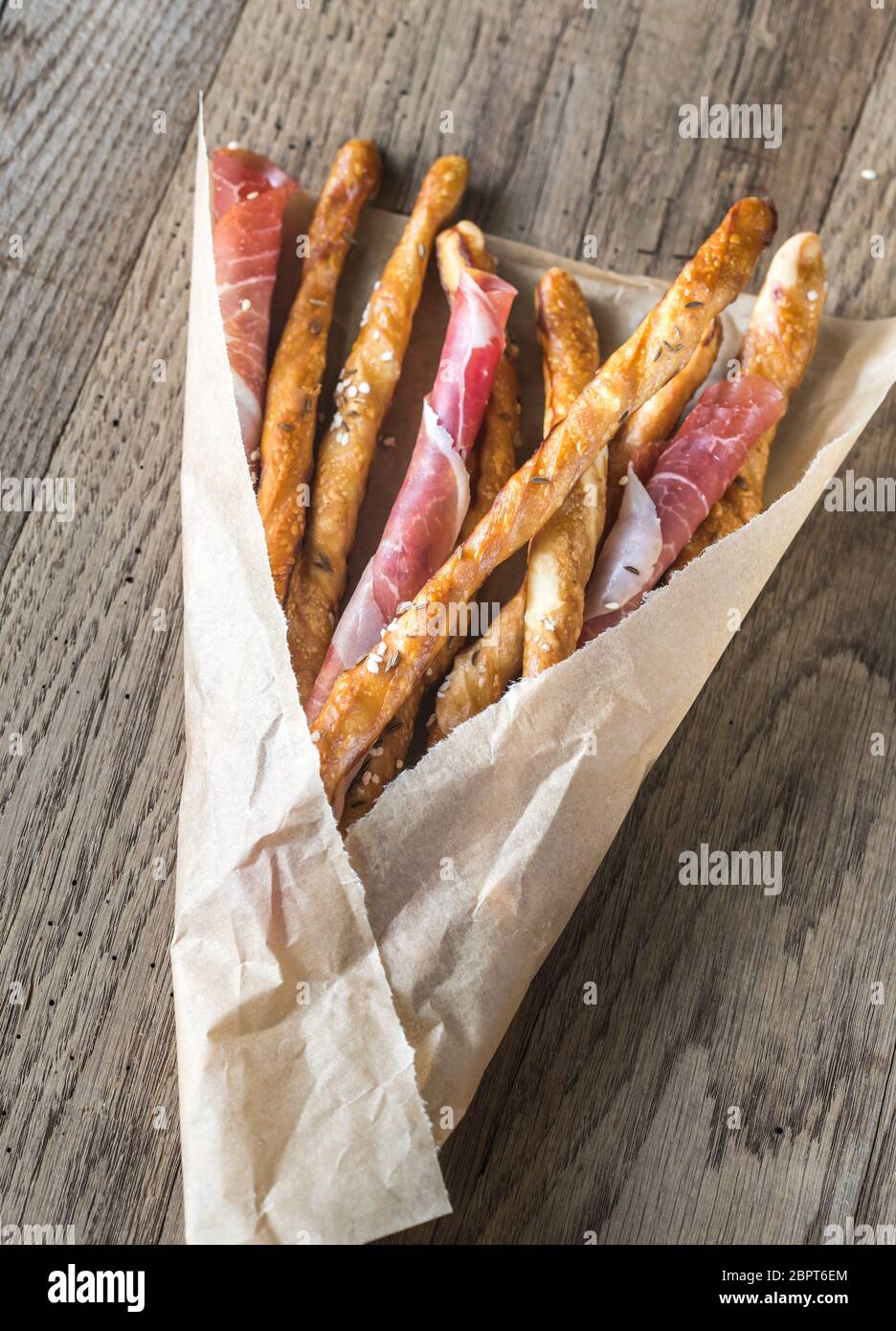 Breadsticks wrapped in jamon Stock Photo - Alamy