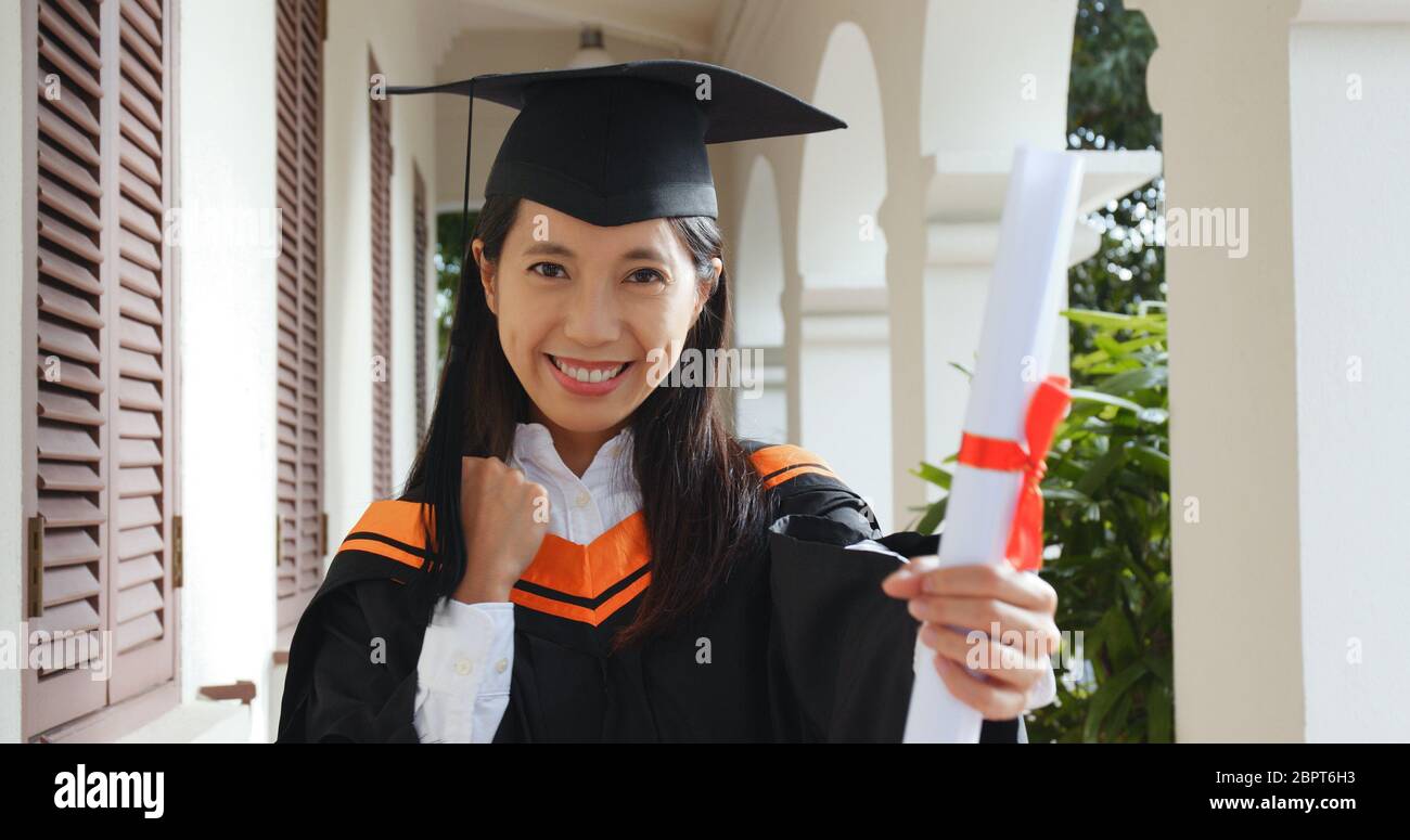 Woman get graduation hold with paper certificate Stock Photo - Alamy