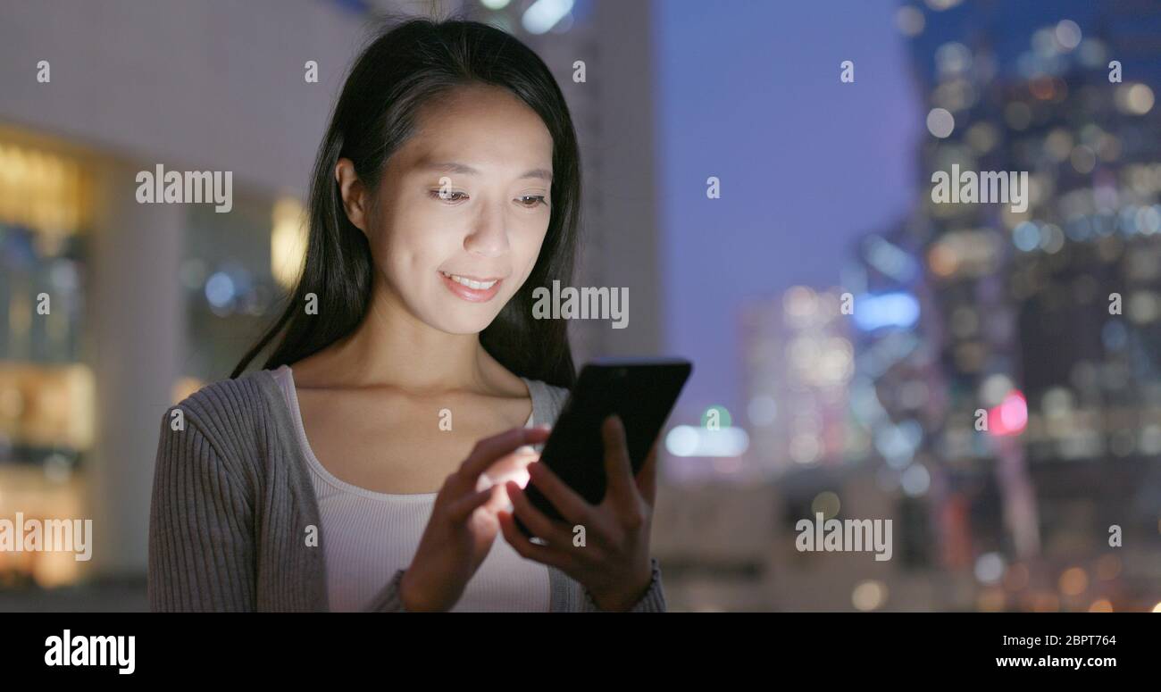 Woman watch on cellphone night hi-res stock photography and images - Alamy