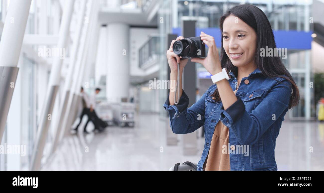 Traveler woman taking photo with camera Stock Photo - Alamy