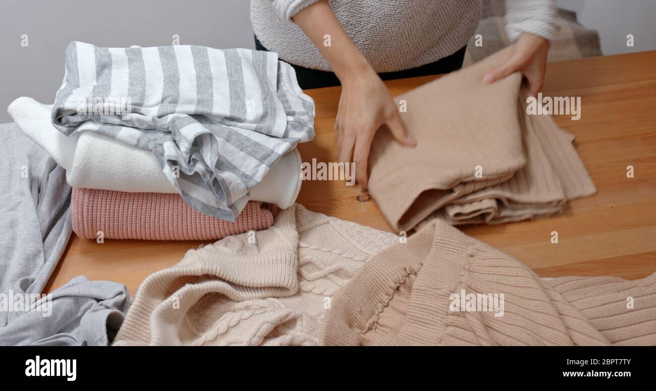 Housewife fold clothes at home Stock Photo - Alamy