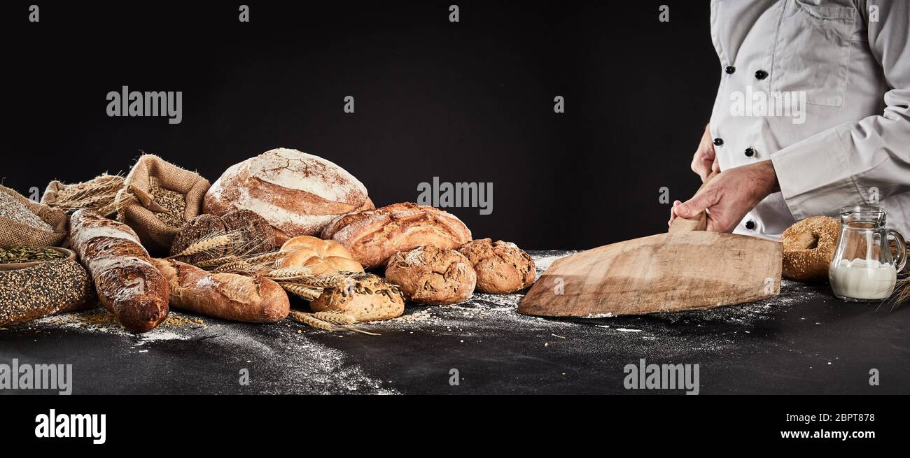 Baker placing an empty wooden paddle on a table ready fore placing ...