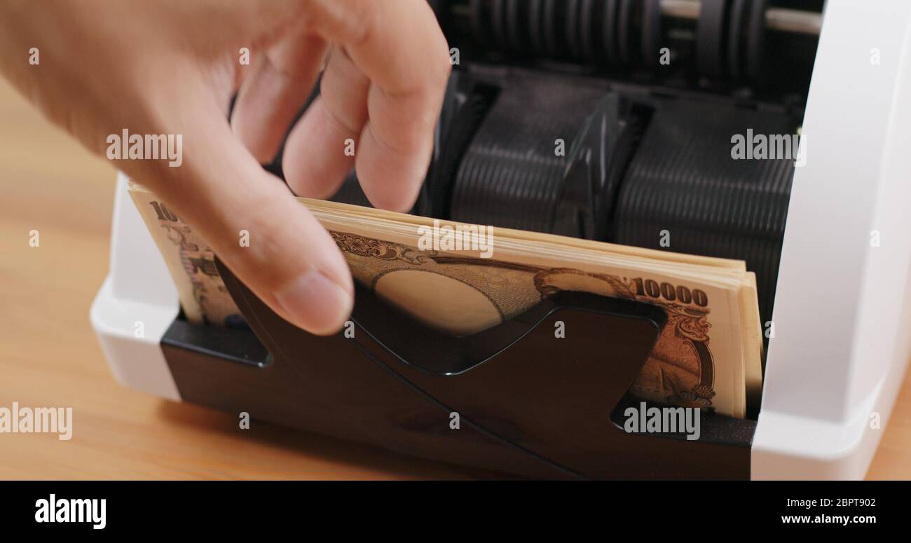 Money counting machine for Japanese banknote machine Stock Photo - Alamy