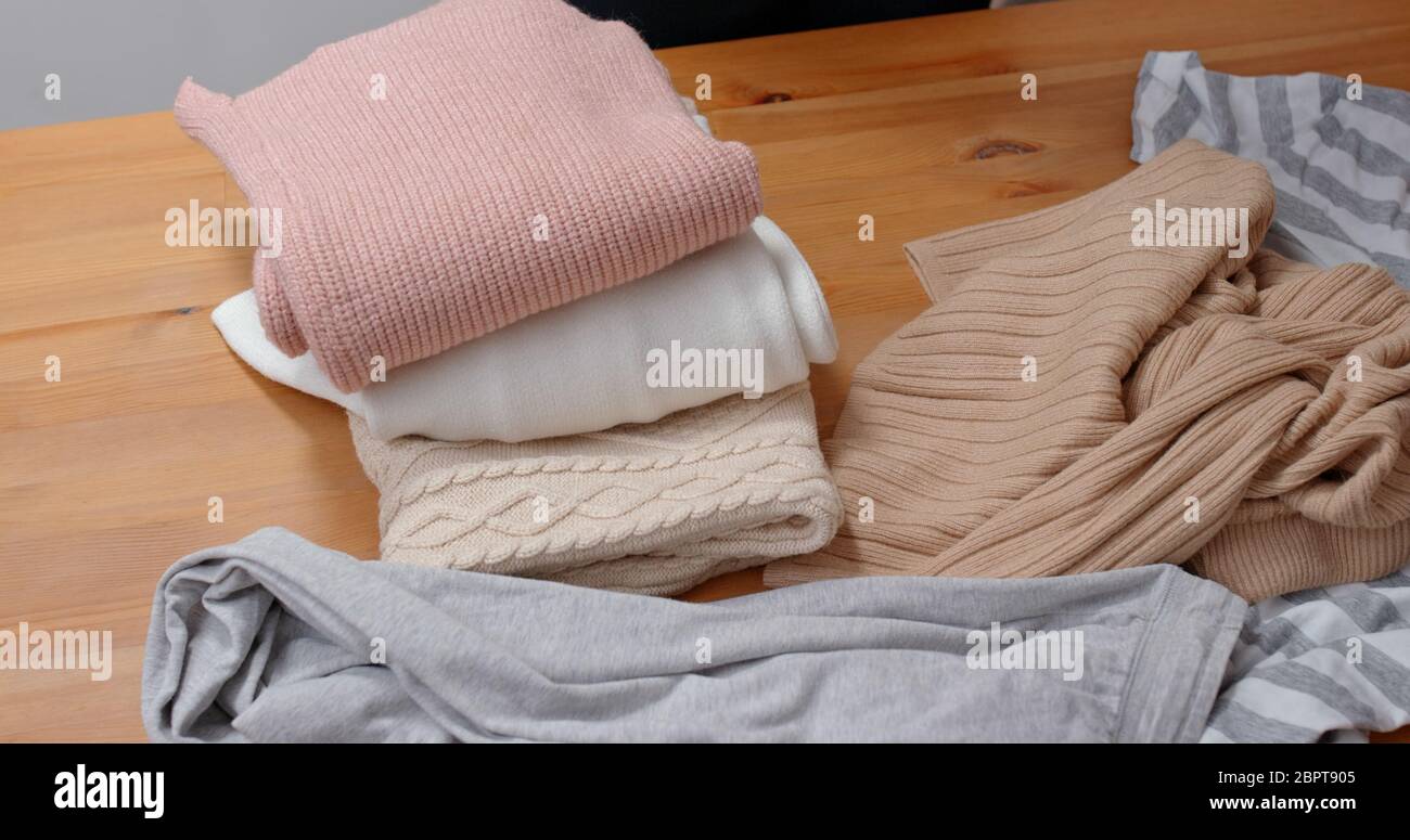 Housewife fold clothes at home Stock Photo - Alamy
