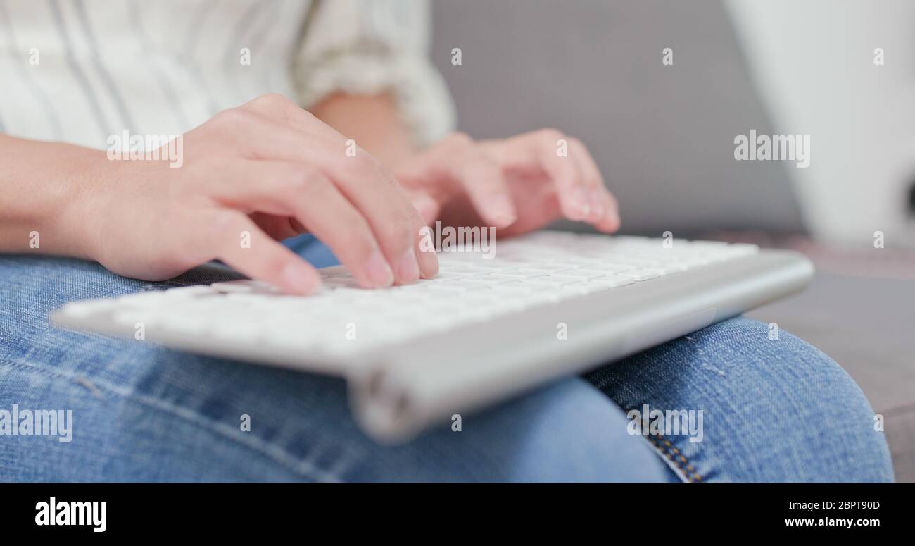 Woman typing on laptop computer Stock Photo - Alamy