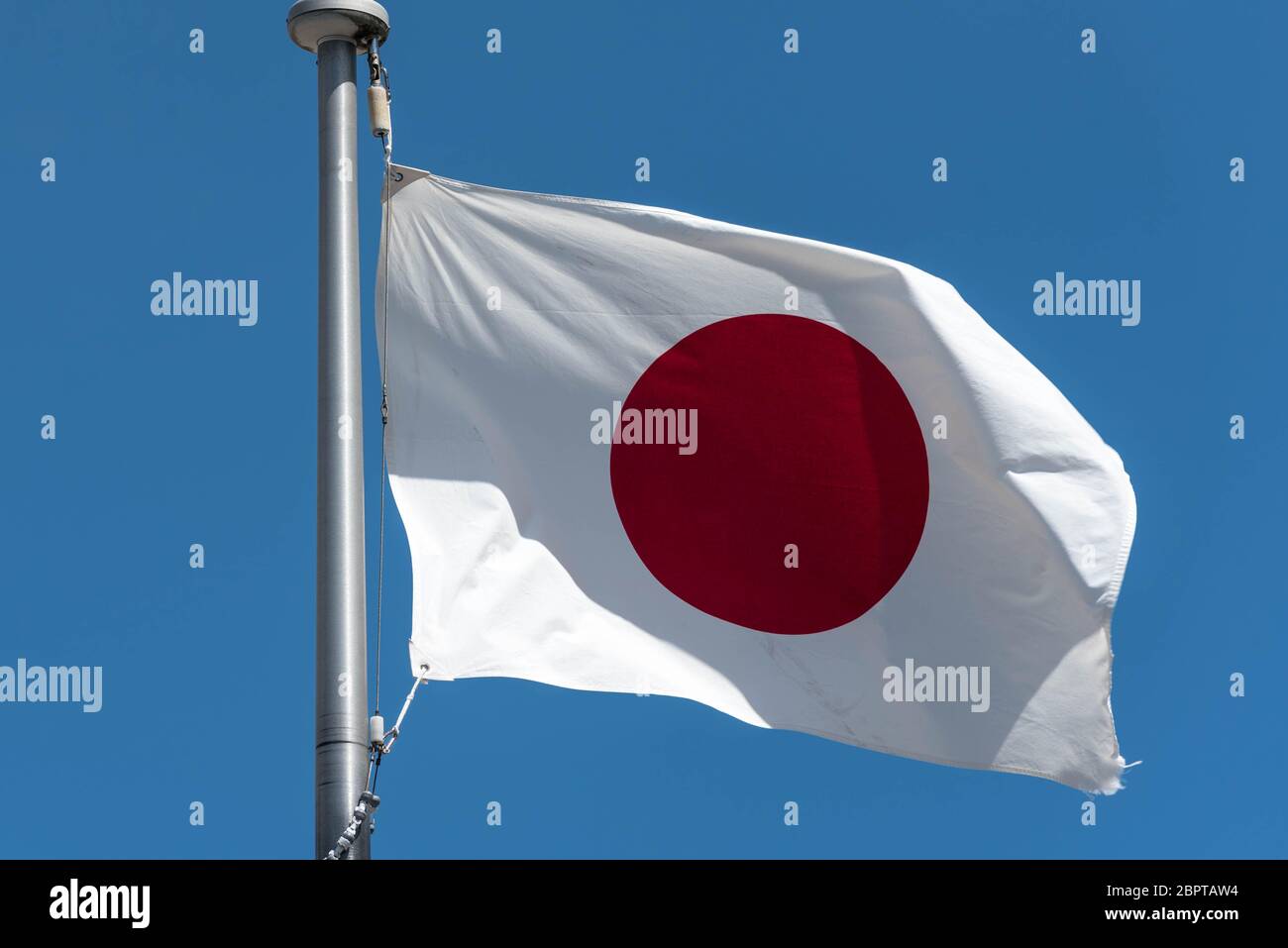 Japan Flag Waving with blue sky background Stock Photo - Alamy