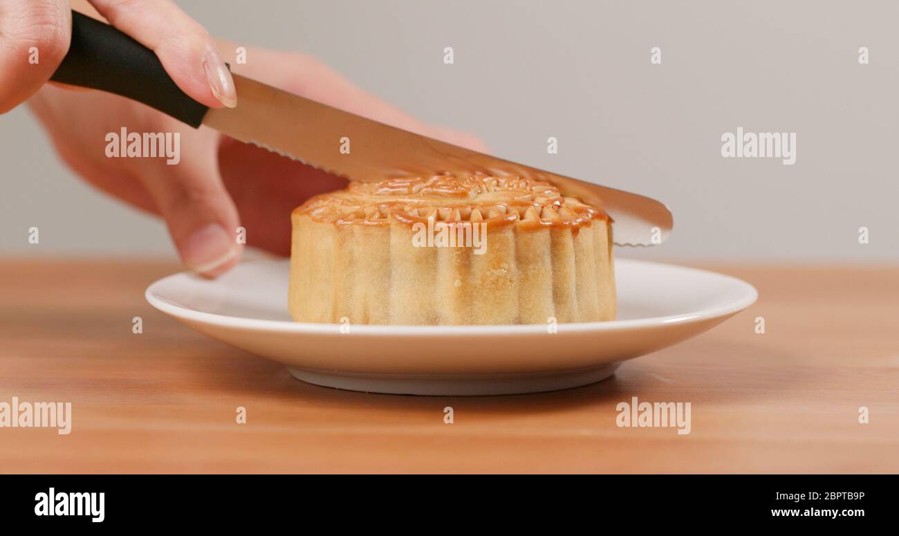 Cutting moon cake for mid autumn festival Stock Photo - Alamy