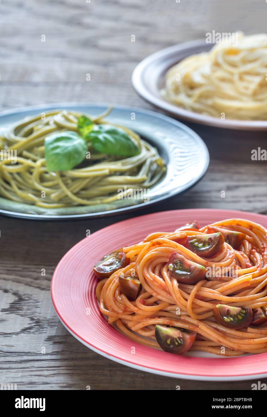 Portions of colorful spaghetti with ingredients Stock Photo - Alamy