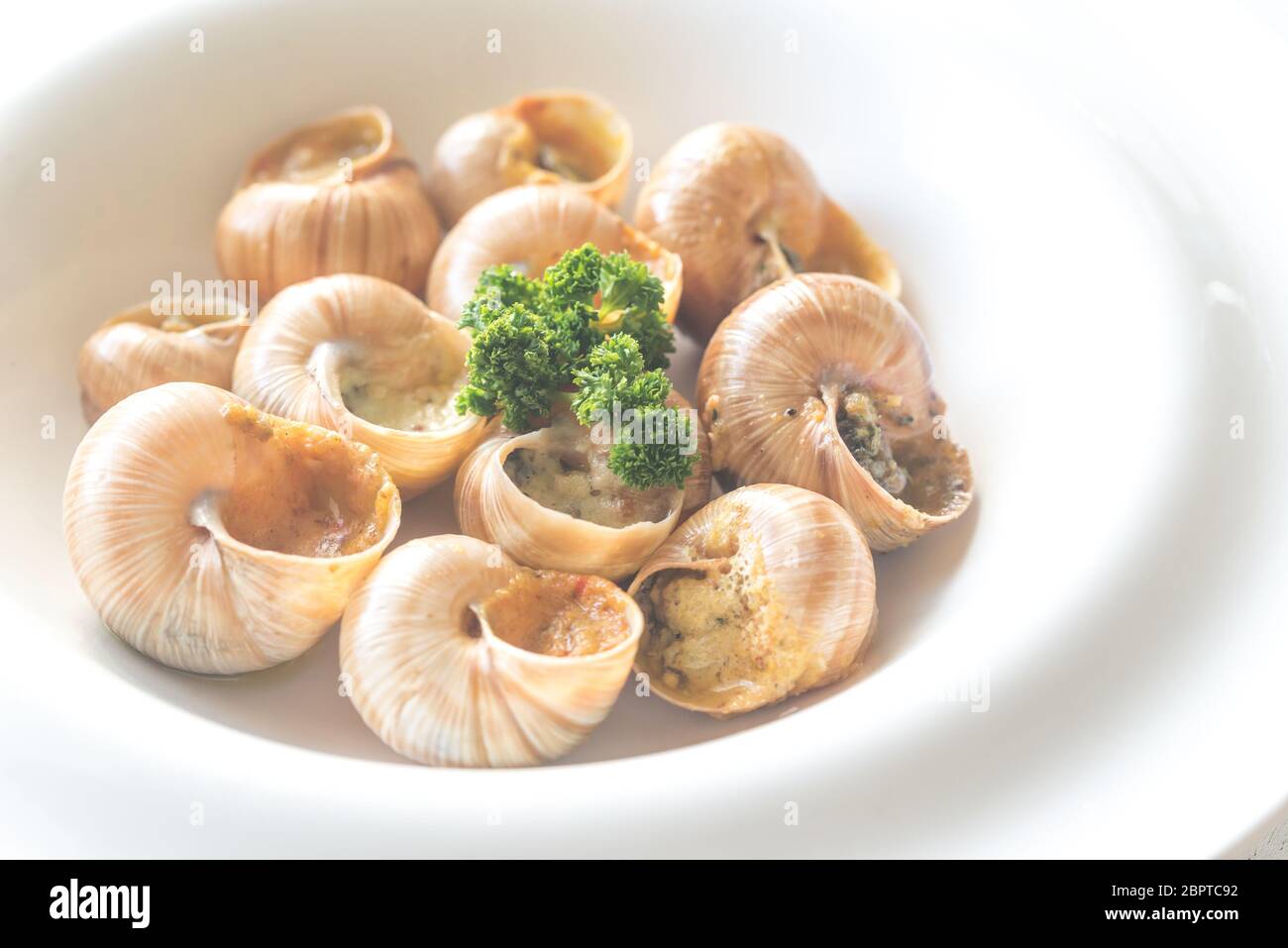 Portion of cooked snails Stock Photo - Alamy