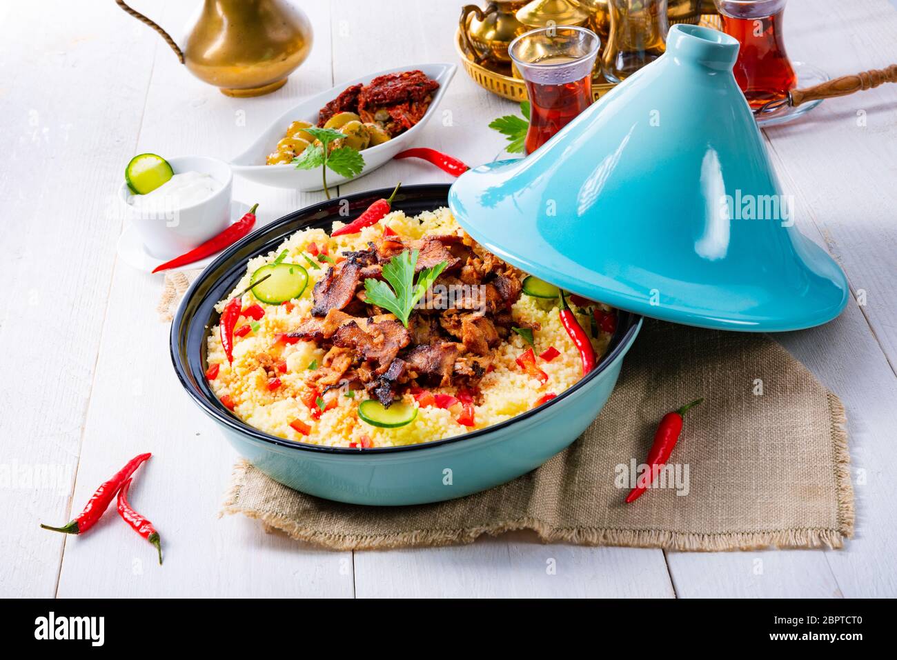 Tajin with couscous, vegetables and meat on white background Stock ...