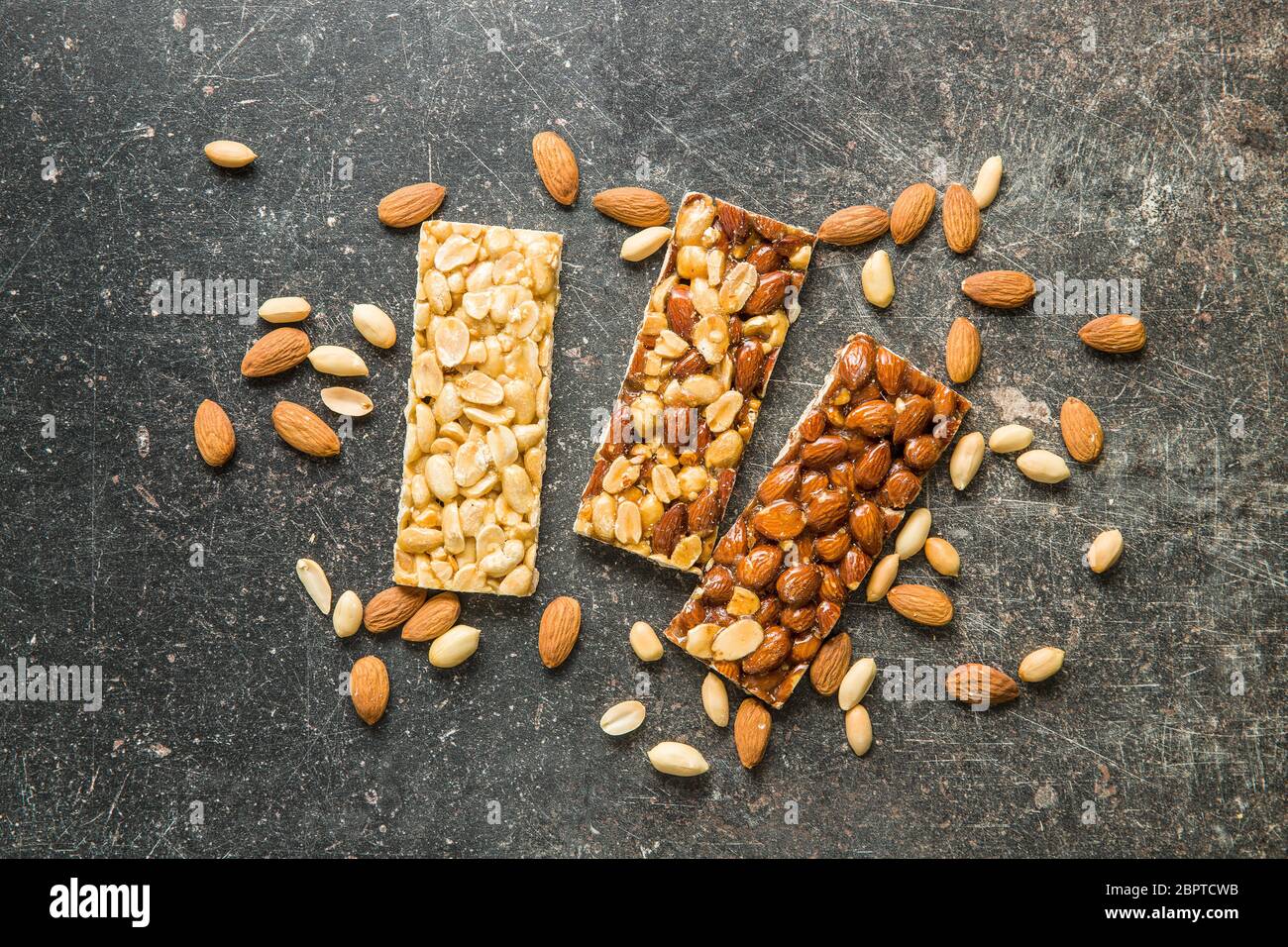 Sweet nut bars with honey on old kitchen table. Top view Stock Photo ...