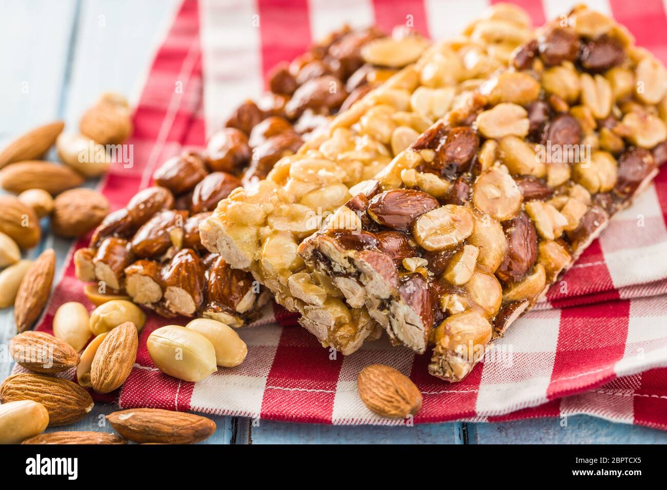 Sweet nut bars with honey on checkered napkin Stock Photo - Alamy