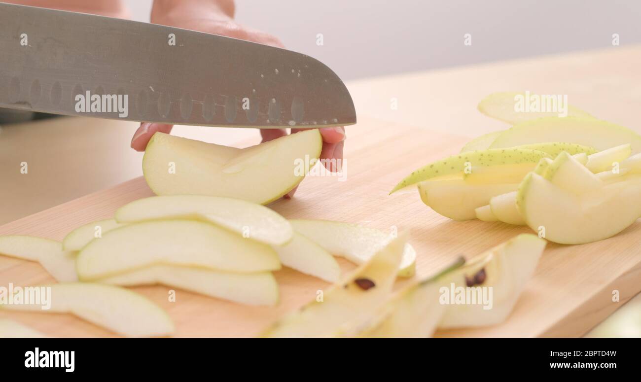 Female hand cutting apple on hi-res stock photography and images - Alamy