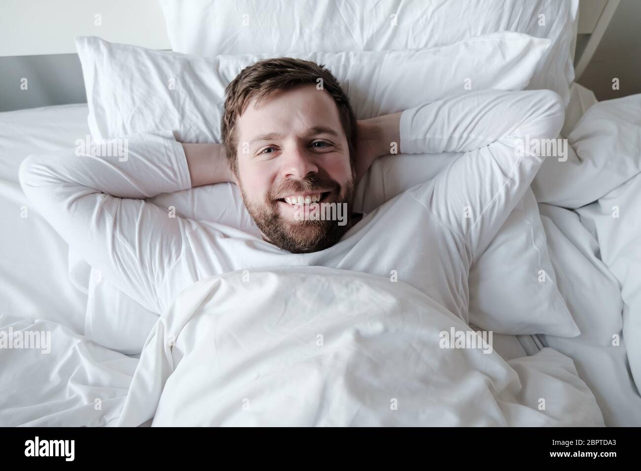 Bearded man lying on bed hi-res stock photography and images - Alamy