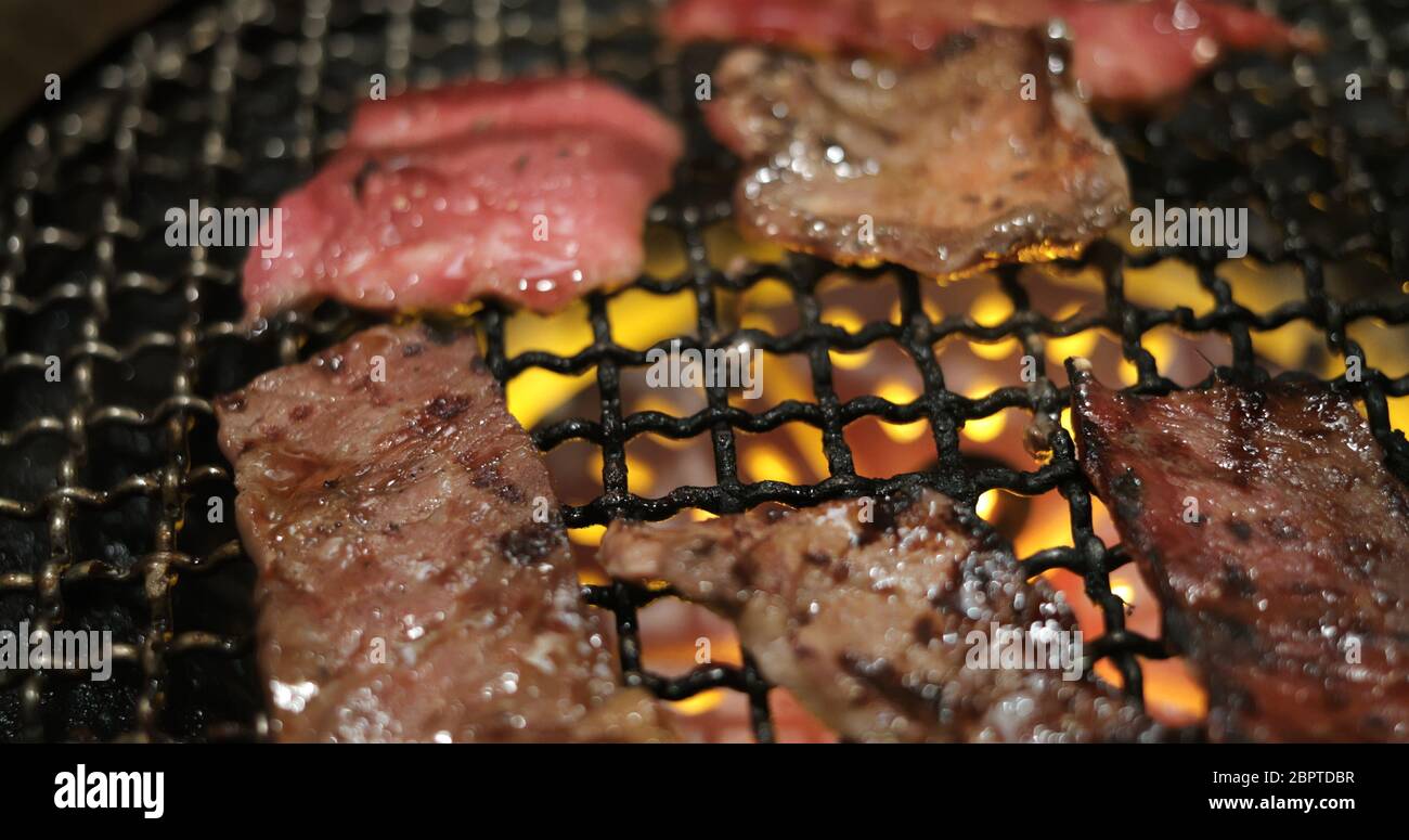Beef meat grill on metal net Stock Photo - Alamy