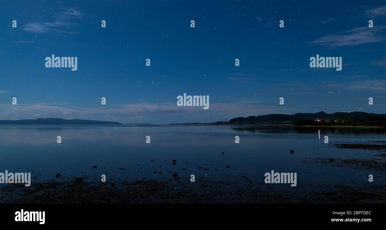 Sea and skyline at night Stock Photo - Alamy