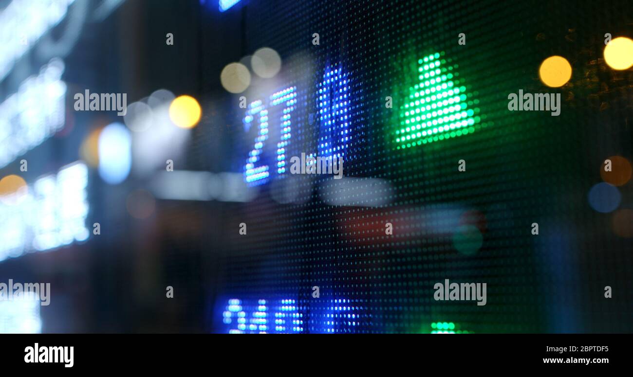 Stock market quotes in city at night Stock Photo - Alamy
