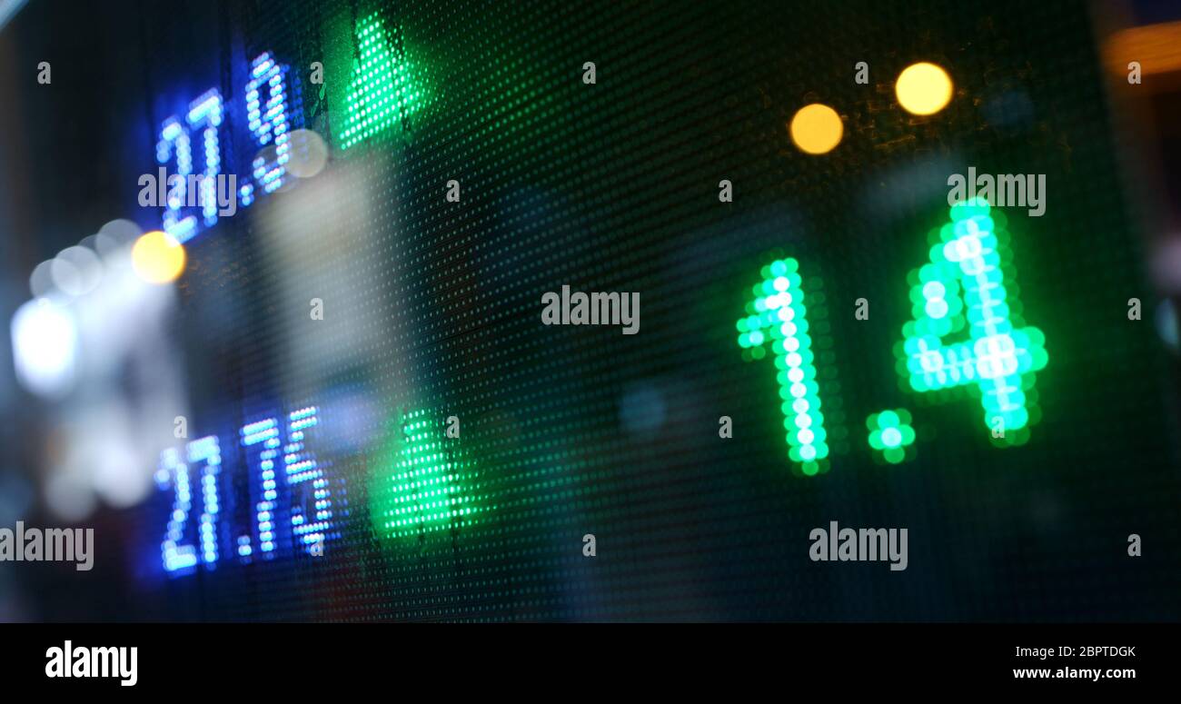 Stock market quotes in city at night Stock Photo - Alamy