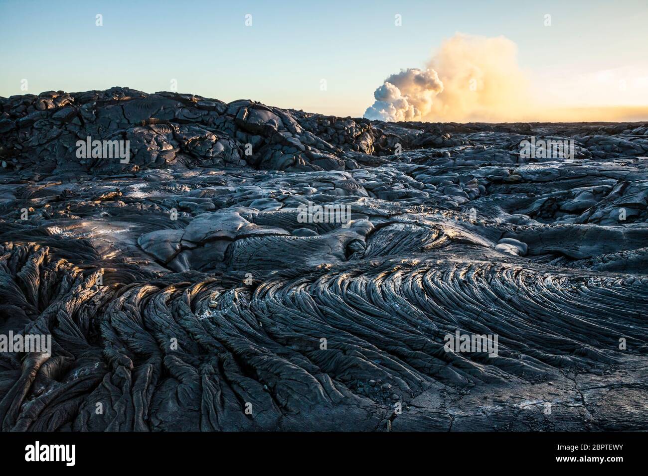 Lava flows and billowing steam in the distant from the lava ocean entry ...