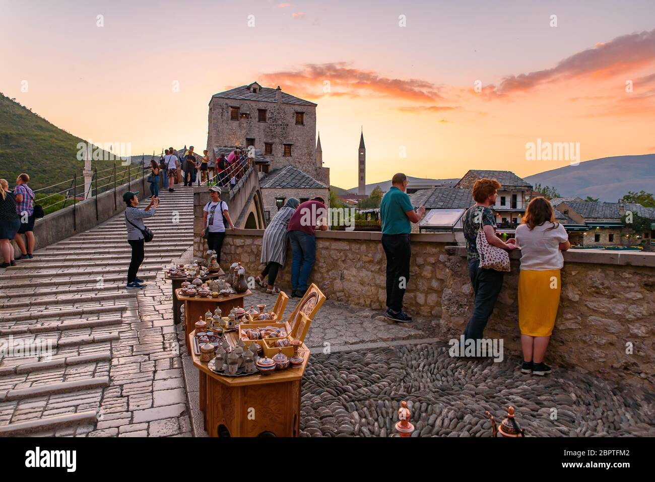 People on the old bridge watching sunset in Mostar, Bosnia and ...