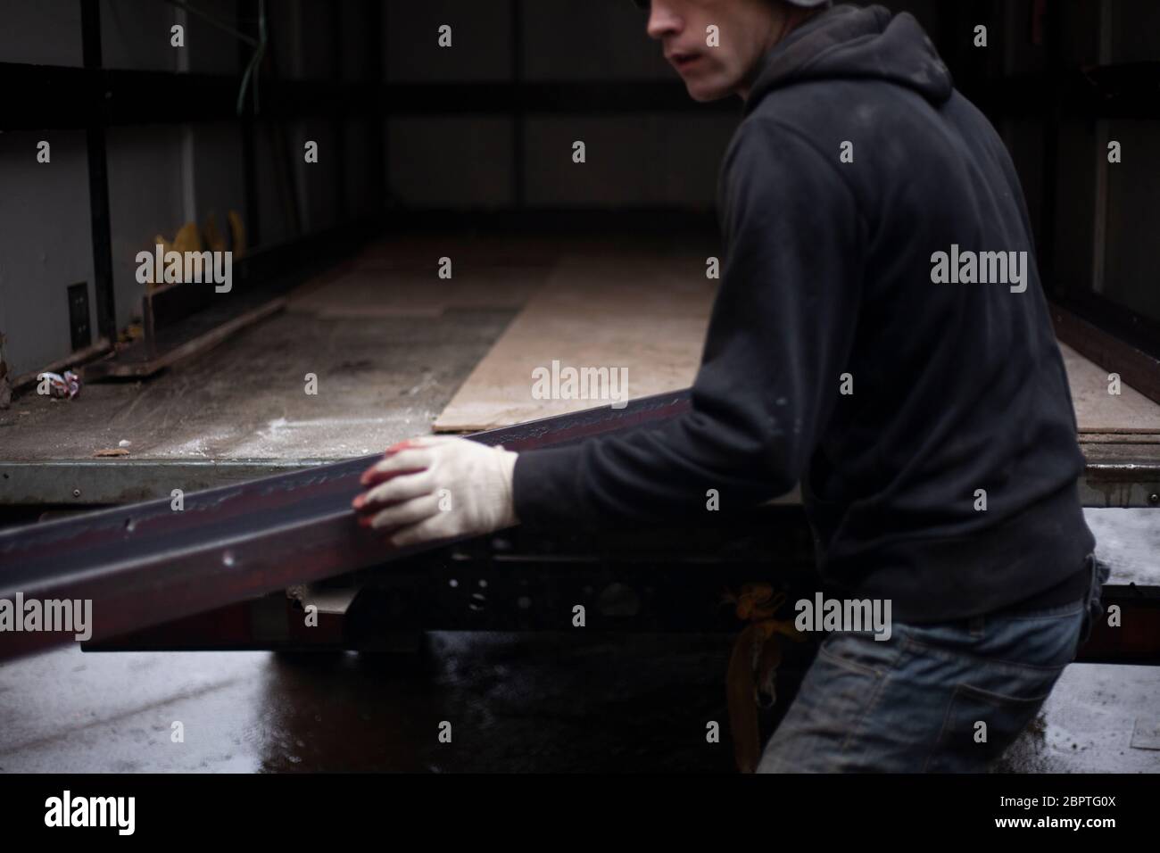 Loaders are loading metal into a lorry. Transportation of heavy ...