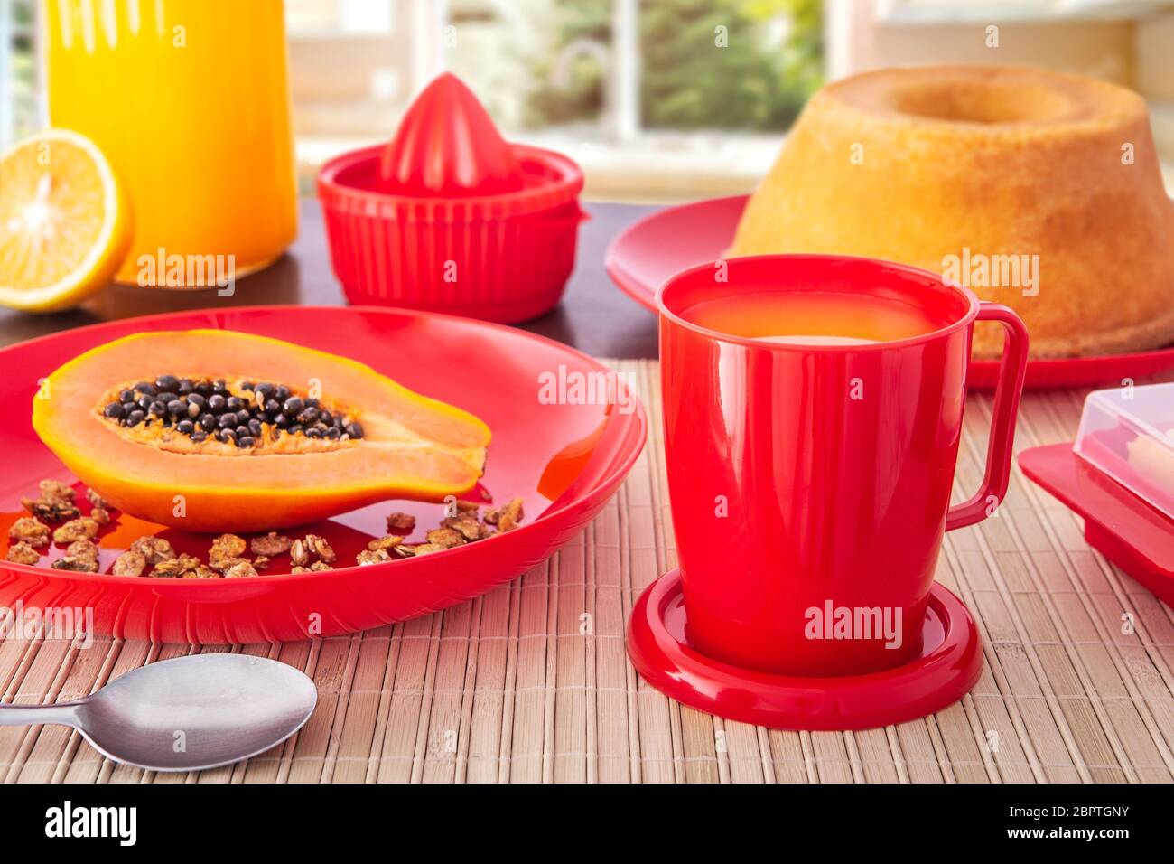 breakfast table with papaya, orange, cake, fruits and bread Stock Photo ...