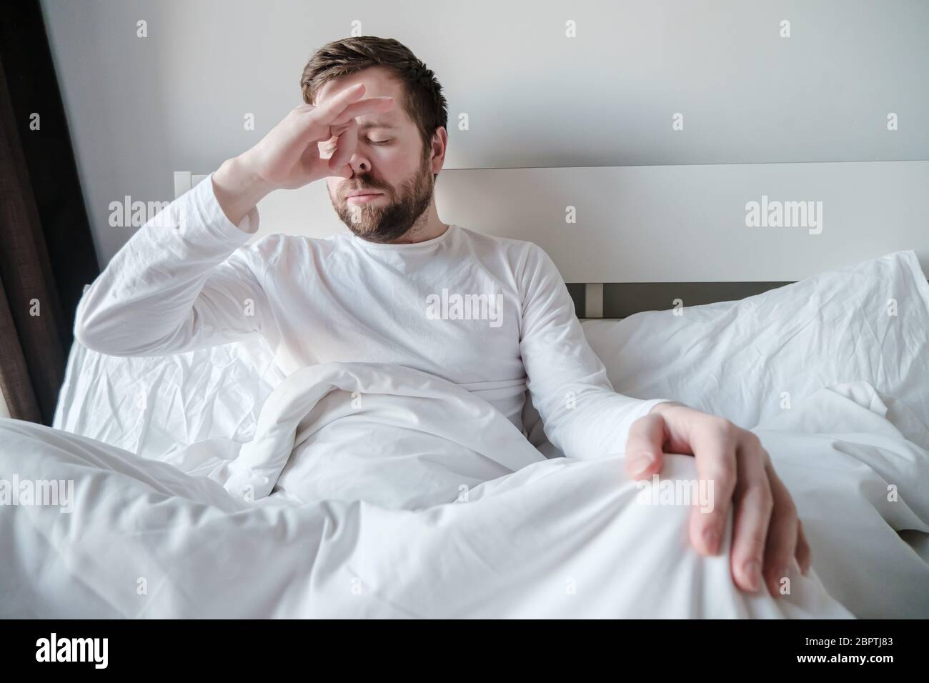 Man practices yoga exercise in the Sukhasan position, he performs the ...