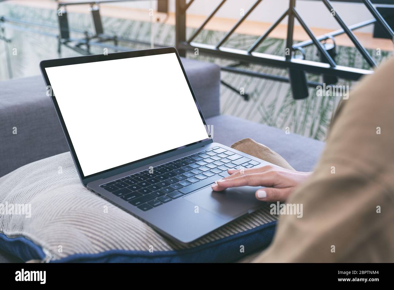 Mockup image of a woman using and touching on laptop touchpad with ...
