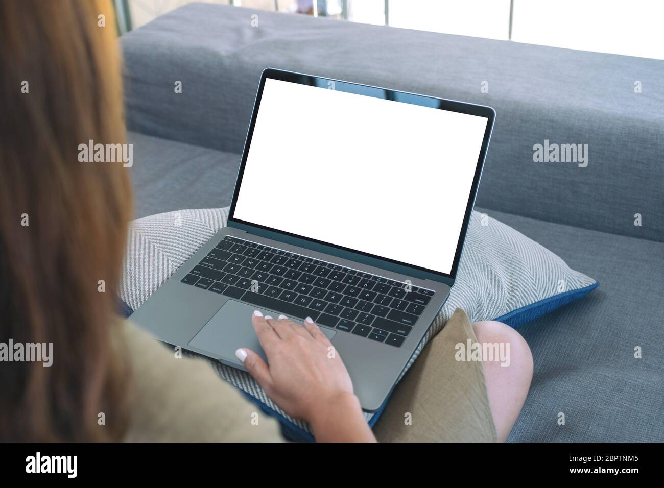 Mockup image of a woman using and touching on laptop touchpad with ...