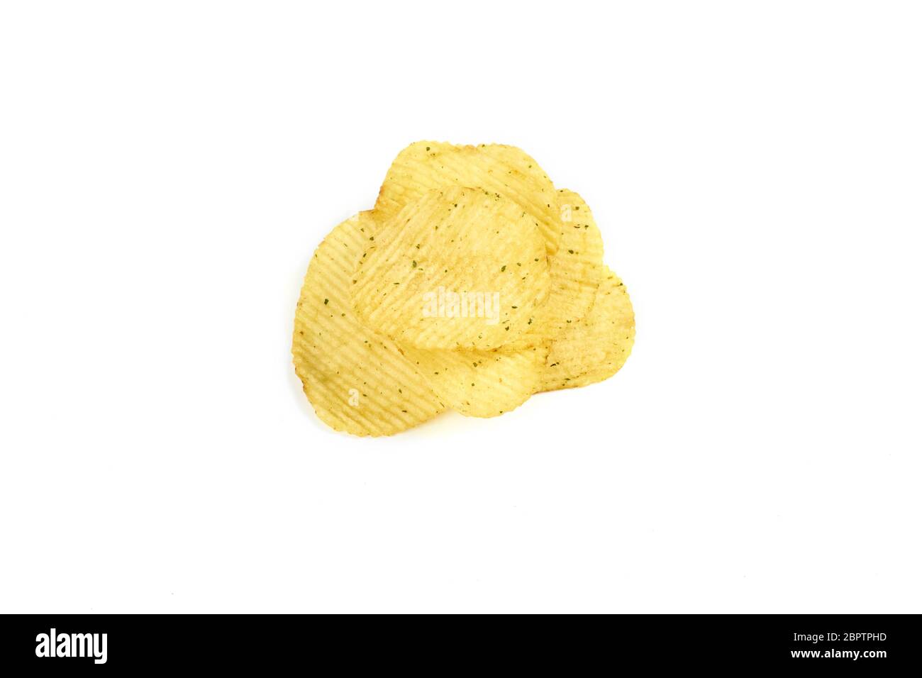 pile of yellow crispy ribbed potato chips isolated on white background ...