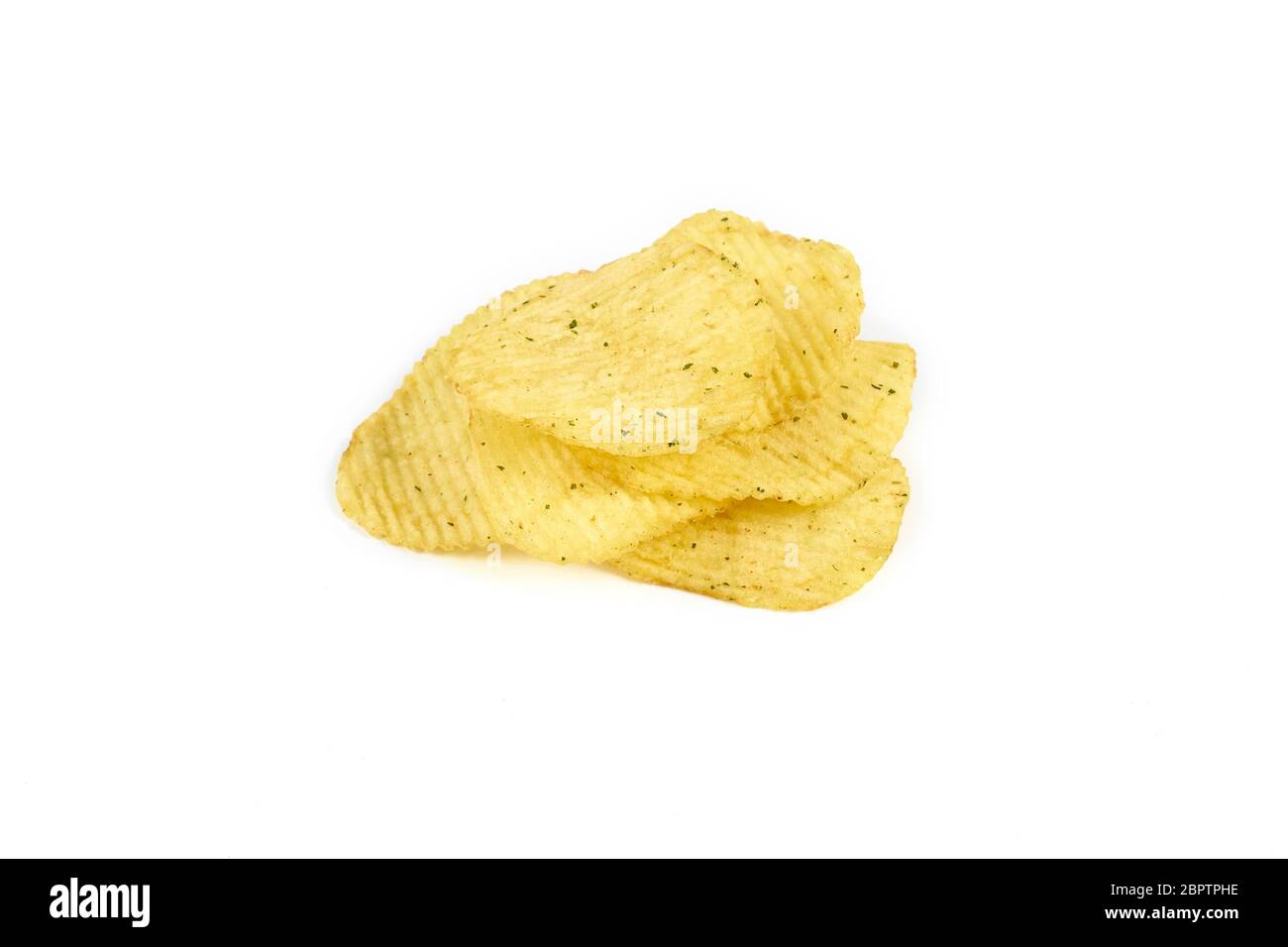 pile of yellow crispy ribbed potato chips isolated on white background ...