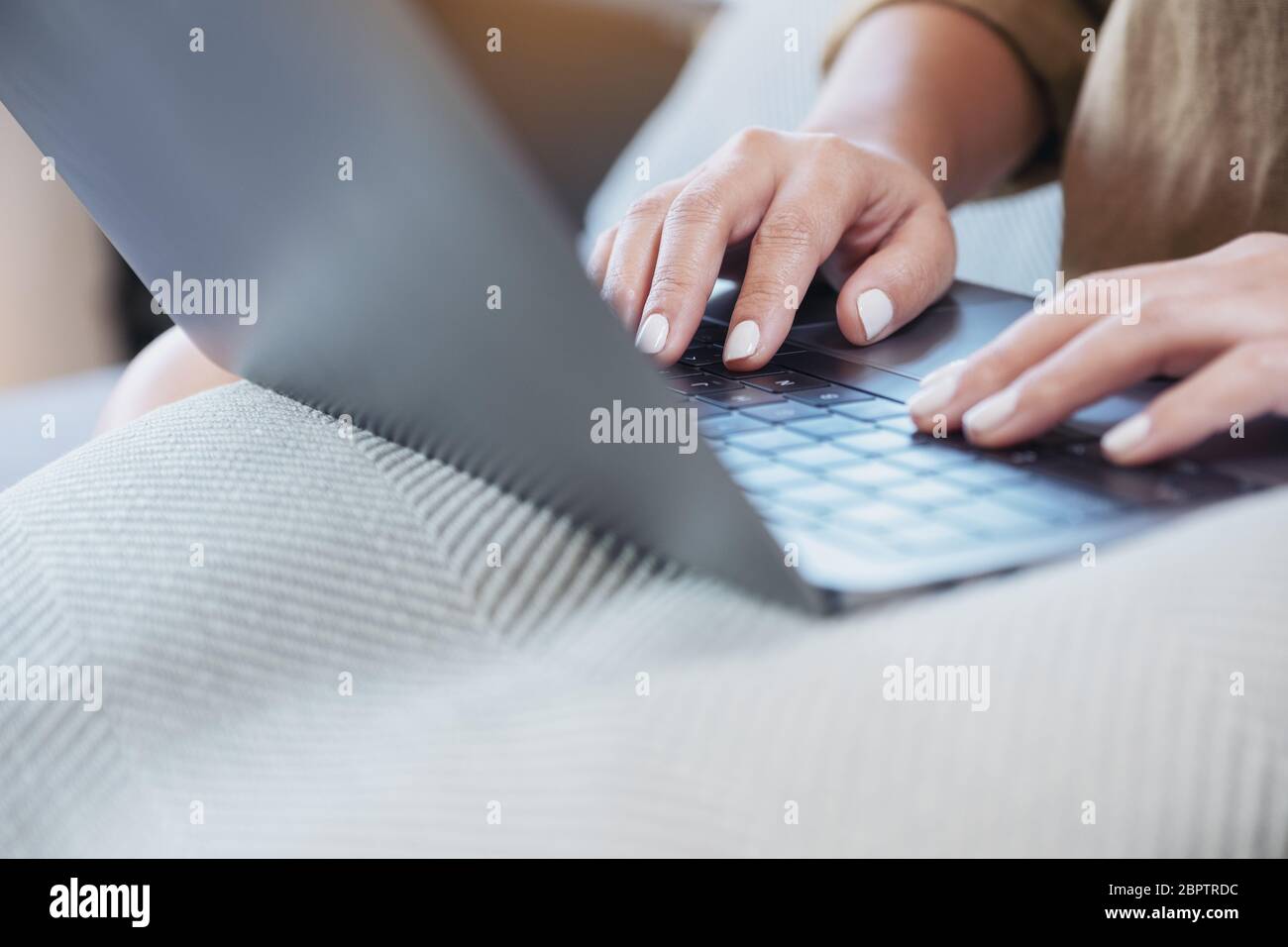 Closeup image of woman's hands using and typing on laptop keyboard ...